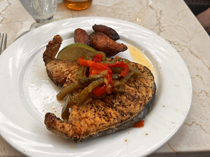 Grilled fish with peppers and plantains—proof that sometimes the simplest preparations let the Caribbean's bounty truly shine.