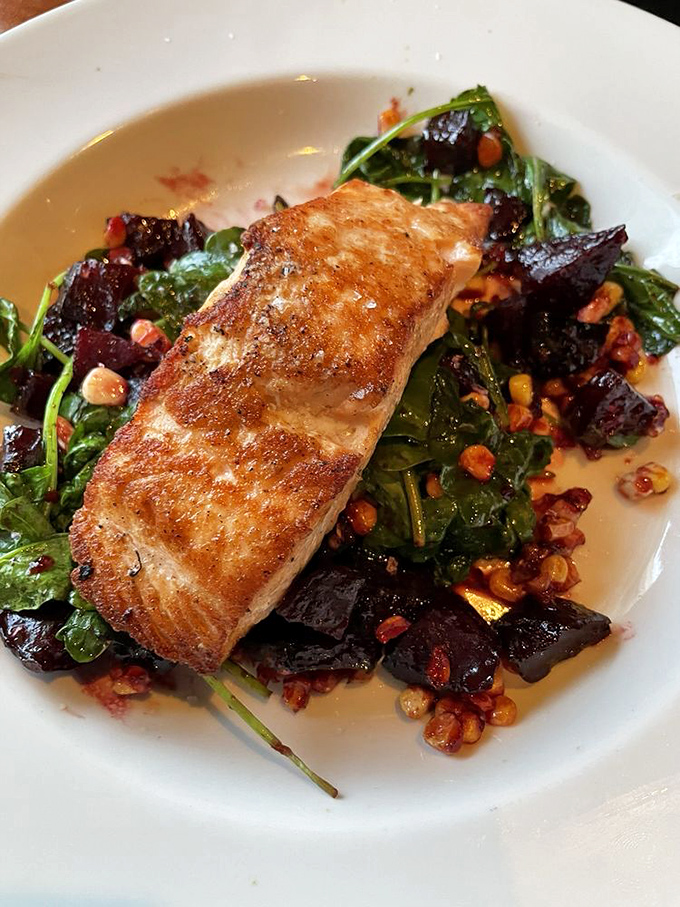 Perfectly seared salmon resting on a bed of greens, beets and corn proves that healthy eating doesn't have to feel like dietary punishment.