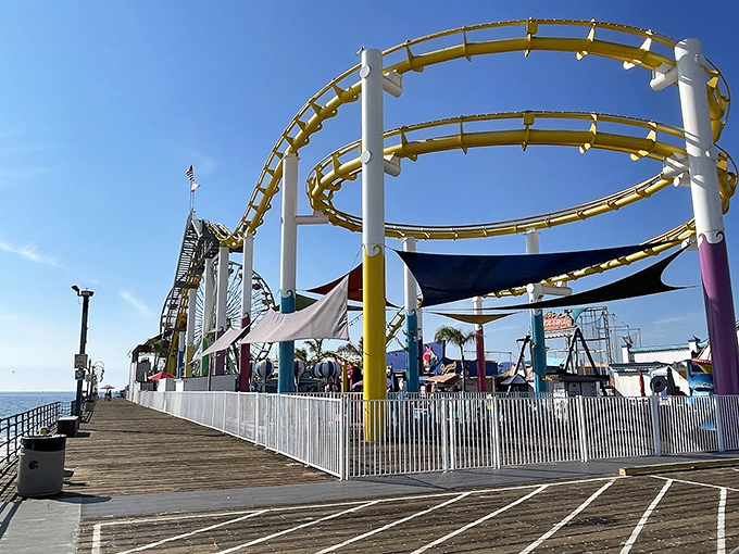 Coaster tracks curve toward infinity above weathered boards, promising seaside thrills that generations before us enjoyed in nearly identical ways.