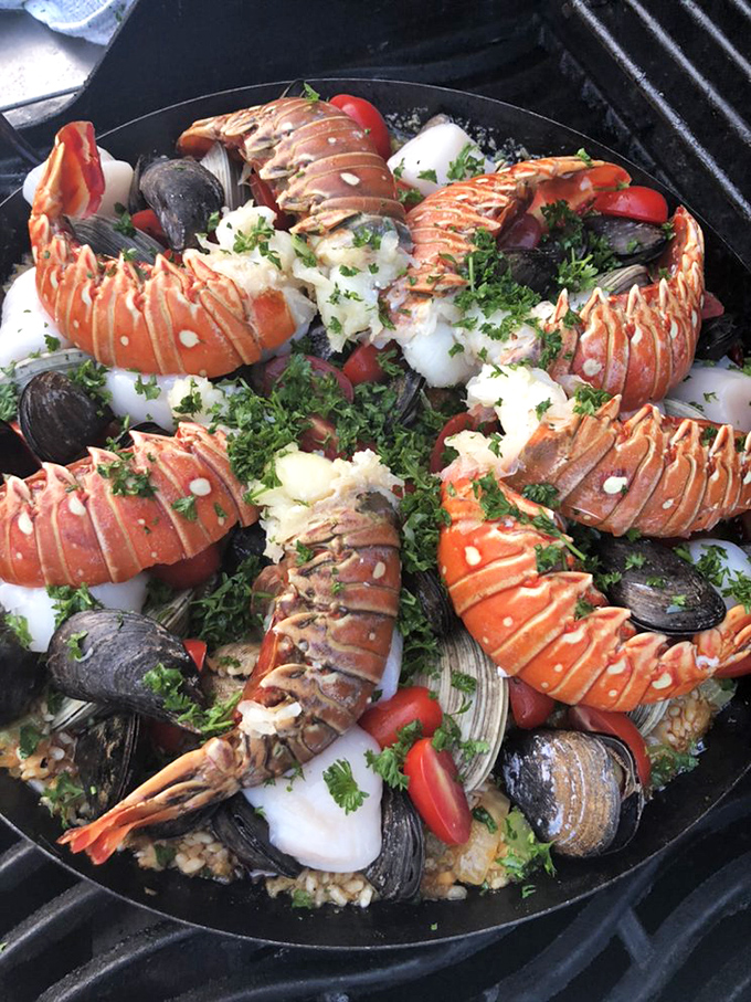 Seafood paella that's worth breaking your diet for. Lobster tails curve gracefully around a bed of rice like synchronized swimmers in a delicious pool.