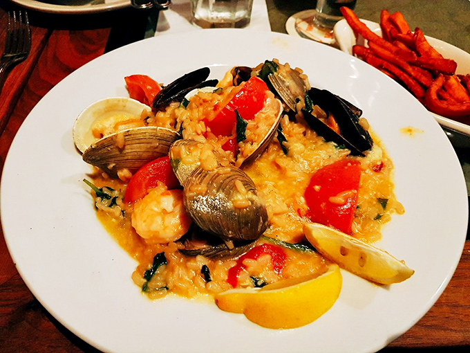 Seafood risotto that's worth every creamy, indulgent bite. Clams, mussels, and shrimp nestled in saffron-kissed rice with bright tomatoes for a dish that's both comfort and luxury.