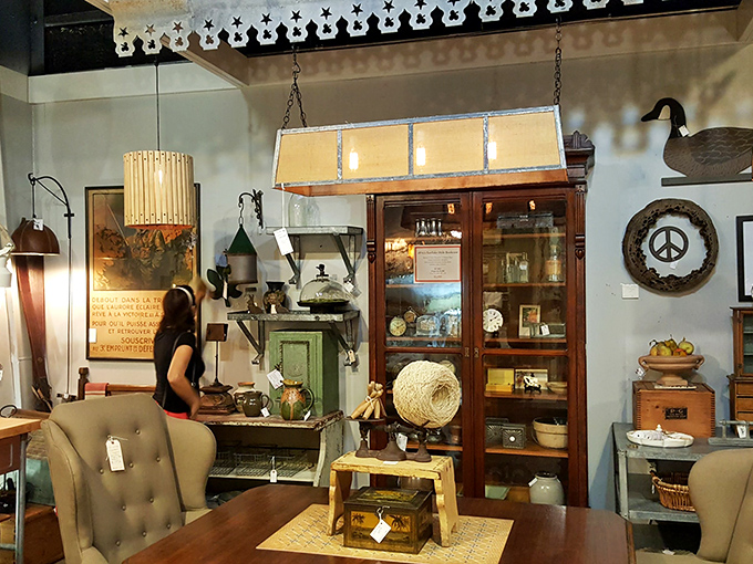 Vintage lighting illuminates carefully curated vignettes where shoppers can envision how these treasures might transform their own spaces.