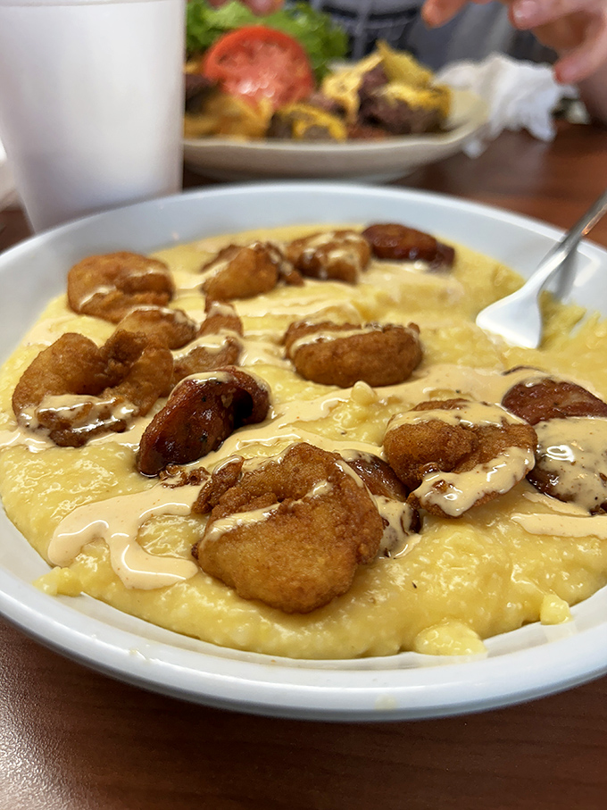 Shrimp and grits that would make a Southerner weep with joy. That creamy base cradling perfectly fried shrimp is comfort food elevated to art.