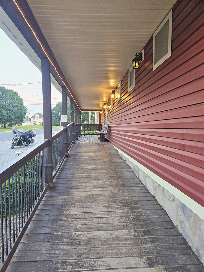 The wooden porch beckons with warm lighting, offering a moment of anticipation before the smoky aromas hit your senses.