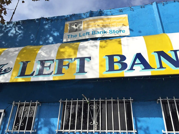 The blue building with yellow signage stands out like a fashion oasis in the urban landscape. Even the exterior refuses to be ordinary.