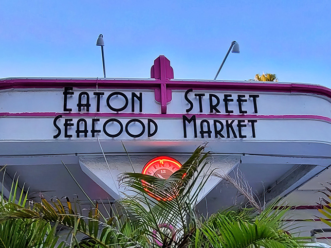 The neon-kissed sign against the twilight sky announces your arrival at seafood nirvana. No fancy font needed when the food speaks for itself.