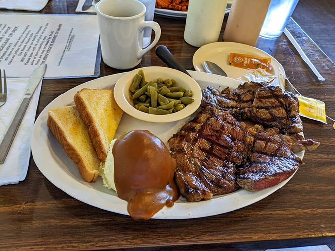 This steak didn't just meet the grill&mdash;they had a passionate affair. The toast and green beans are just trying not to feel awkward about it.