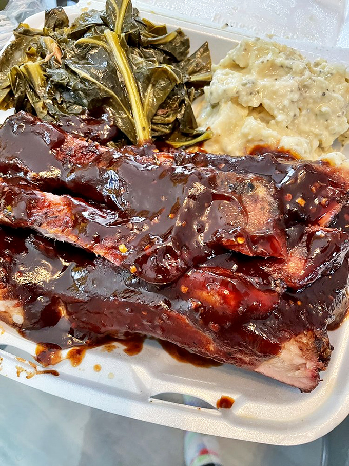 Saucy ribs nestled beside collard greens and potato salad&mdash;a trifecta of Southern comfort that makes you want to hug your plate.