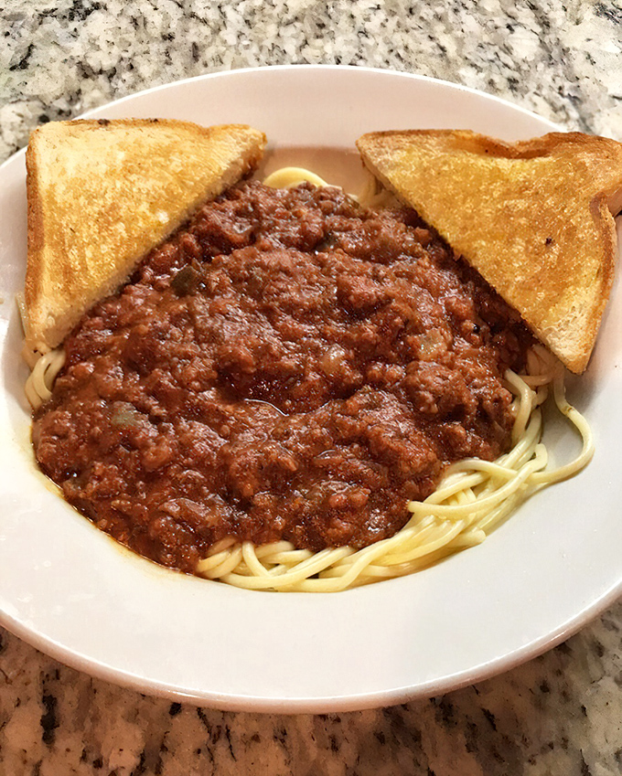Spaghetti with meat sauce and toast&mdash;comfort food that doesn't need a passport to prove its worth.