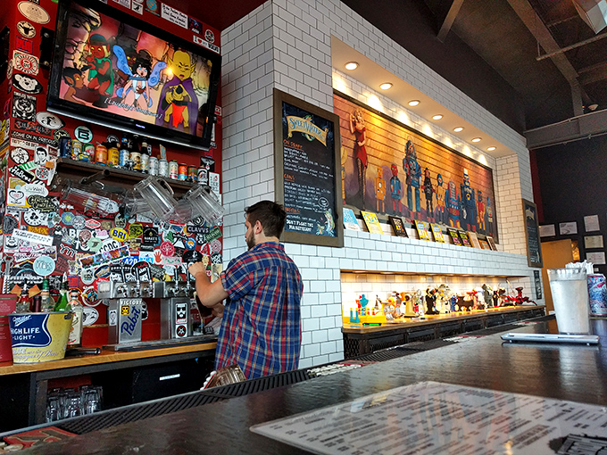 The bar area showcases superhero figurines and pop culture memorabilia – because saving the world and saving your appetite go hand in hand.