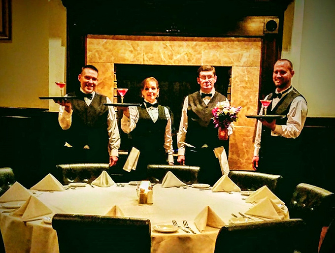 The staff, dressed in classic black and white, ready to orchestrate your culinary journey with the precision of a symphony and warmth of old friends.