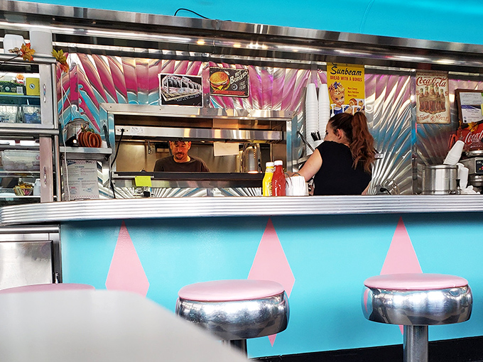 The pass-through window: where kitchen magic transforms into table treasures. The heartbeat of any great American diner.