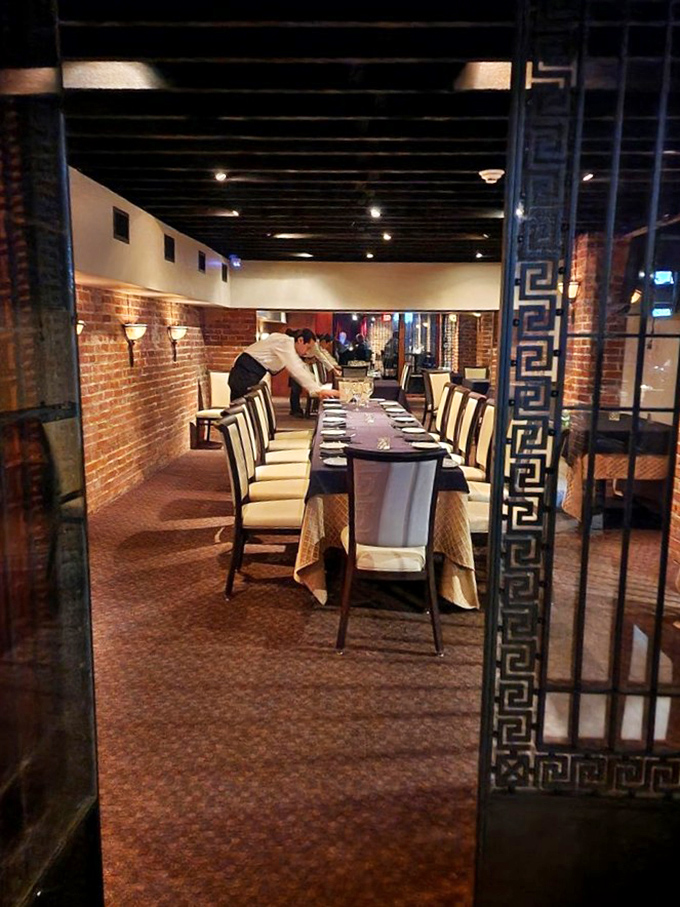 A glimpse into the private dining room, where attentive staff prepare for guests who will soon create memories around this elegant table.