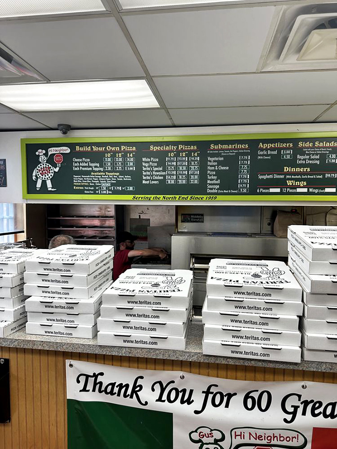 Behind the counter, pizza boxes stand in formation like delicious soldiers awaiting deployment to hungry homes across Columbus.