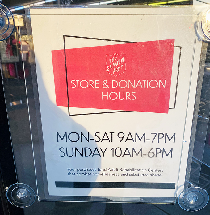 The store hours sign reminds shoppers that their treasure hunting funds a mission greater than bargains&mdash;community transformation happens here daily.
