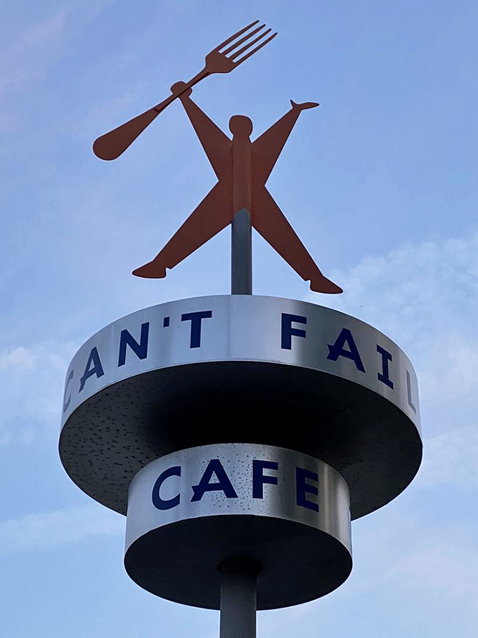 The restaurant's iconic mascot&mdash;fork in hand, ready to eat&mdash;stands tall above the Rudy's sign, a beacon for hungry travelers.