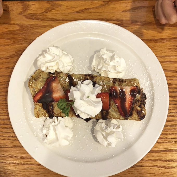 French toast gets dressed for a special occasion with strawberries and whipped cream—breakfast masquerading as dessert, and nobody's complaining.