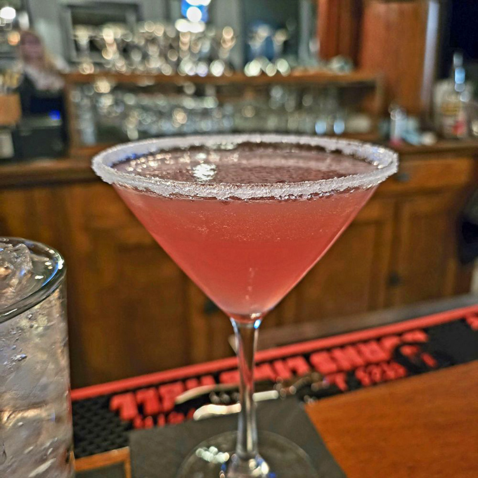 This sugar-rimmed martini, blushing pink like a sunset, promises sweetness with just enough tartness to keep things interesting.