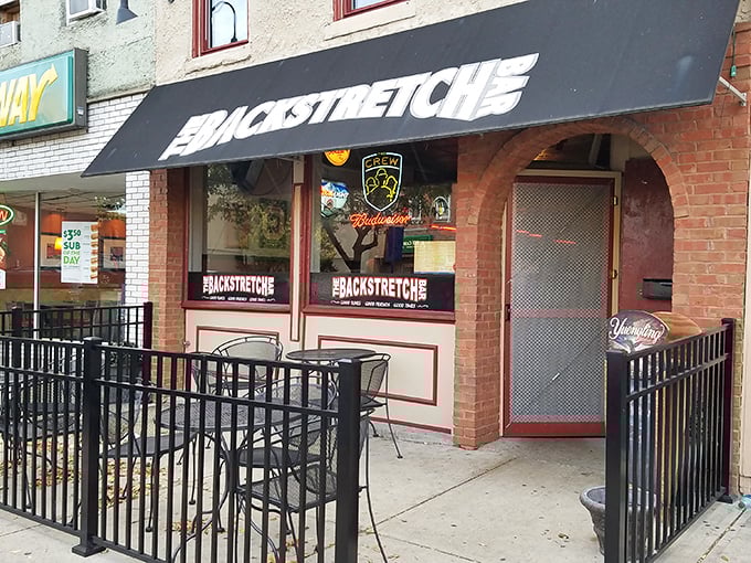 The Backstretch offers sidewalk seating where people-watching becomes an Olympic sport and conversations flow as freely as whatever's in your glass.