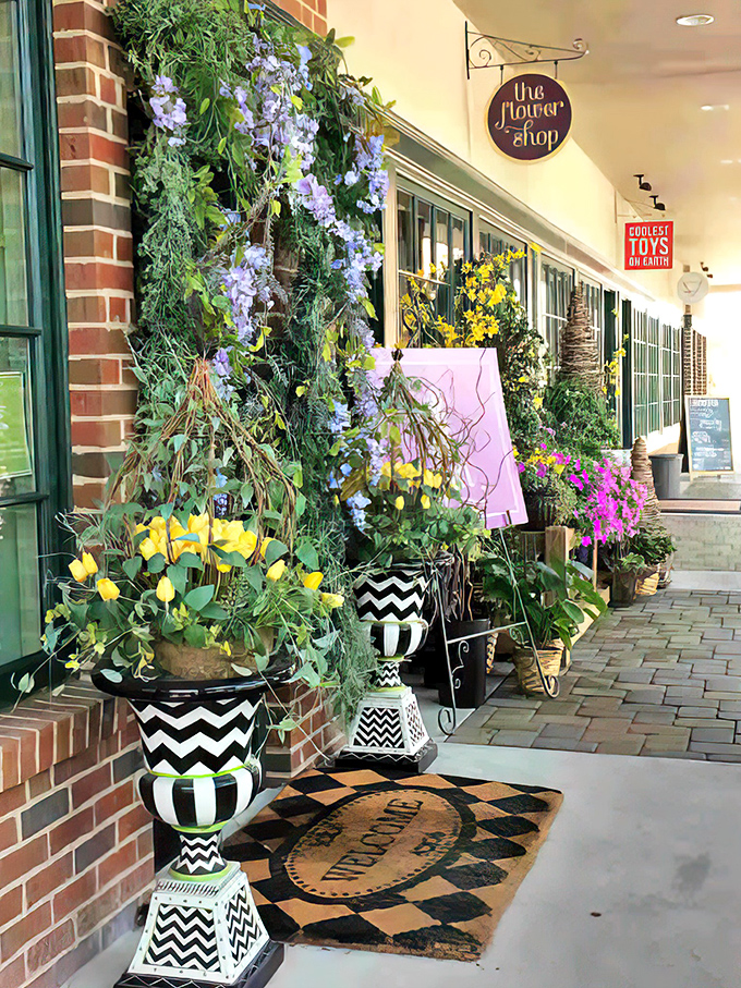 The Flower Shop's vibrant display spills onto the sidewalk like nature refusing to be contained, adding splashes of color to Mariemont's village scene.