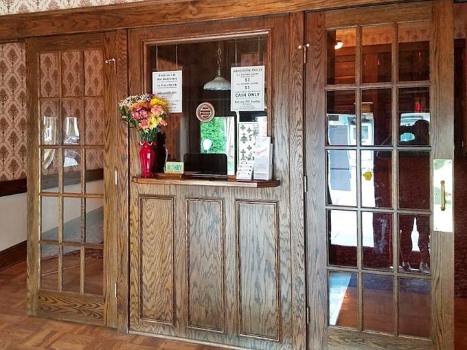 The ticket booth's oak paneling and vintage window create that perfect first impression: you're not just buying admission, you're purchasing a passport to another world.