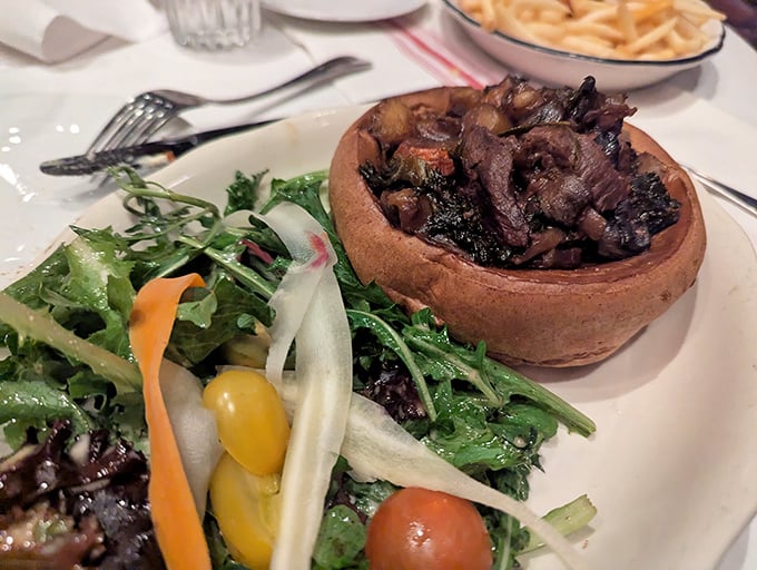 Toad in the hole&mdash;a savory Yorkshire pudding filled with tender meat&mdash;comes with a side salad that somehow makes you feel virtuous while indulging.