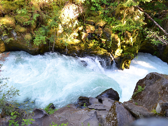 Mother Nature's perfect blue-green cocktail, shaken not stirred, flowing through volcanic rock with effortless grace.