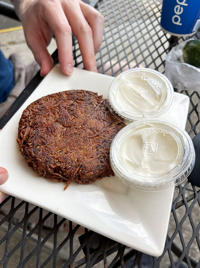 The potato knish arrives like a bronzed masterpiece, crispy exterior giving way to a cloud of potato that puts ordinary spuds to shame.