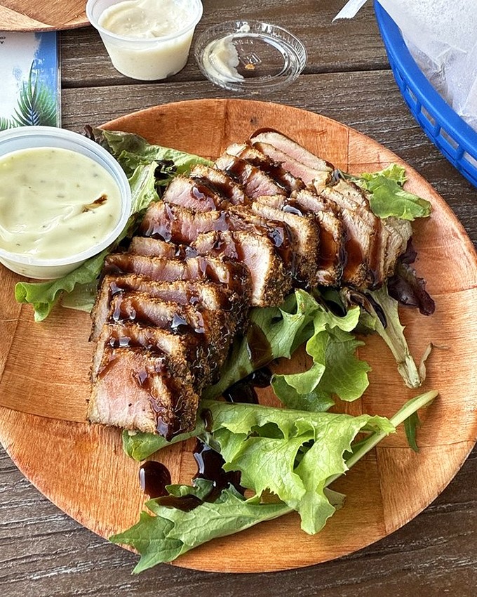 Seared tuna that respects the fish. Perfectly cooked with a pink center, this plate balances protein and greens with artistic precision.