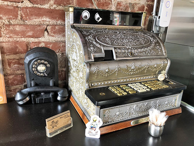 The antique cash register stands like a beautiful artifact from a time when "Apple Pay" meant bringing the farmer a McIntosh.