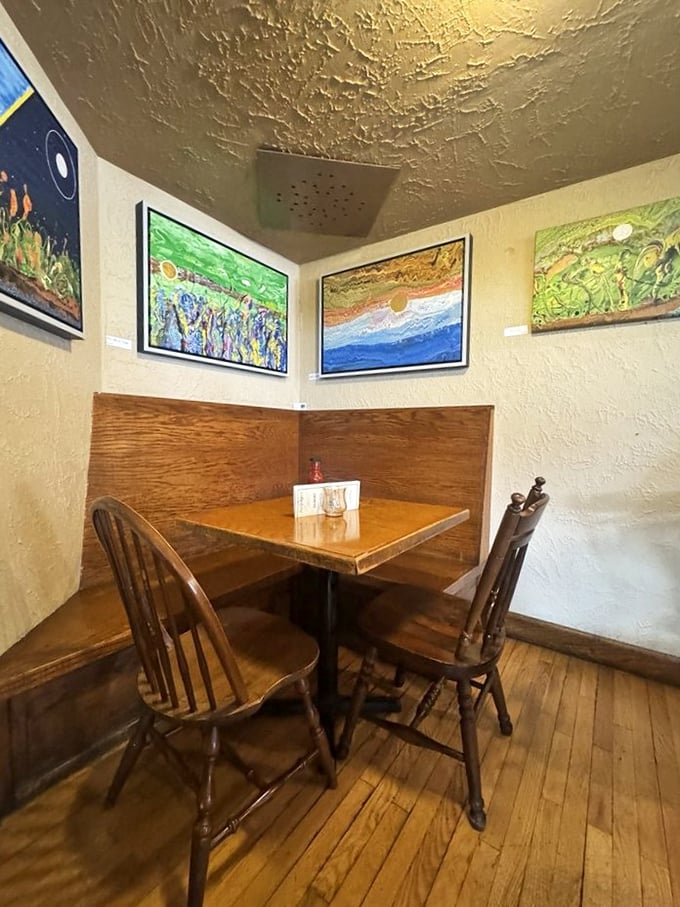 A cozy corner where local art transforms a simple meal into a cultural experience. This table has heard more first dates than a matchmaking service.
