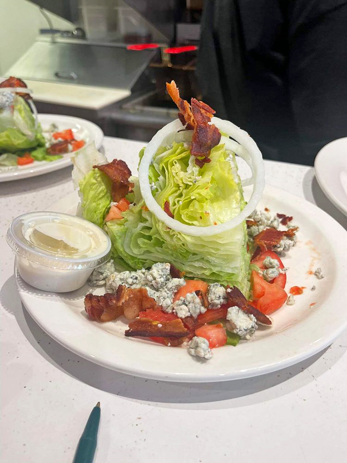 This wedge salad proves vegetables can be exciting when properly introduced to bacon, blue cheese, and a perfectly sliced onion ring.
