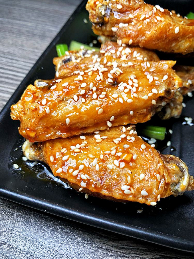 Wings where the sesame seeds aren't just garnish&mdash;they're little crunchy exclamation points punctuating each bite of sticky-sweet goodness.