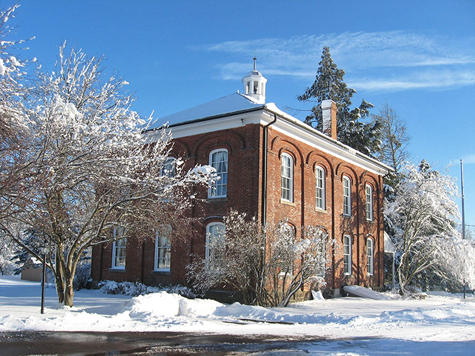 Winter snow blankets the historic buildings, creating a scene that would make Currier and Ives jealous.