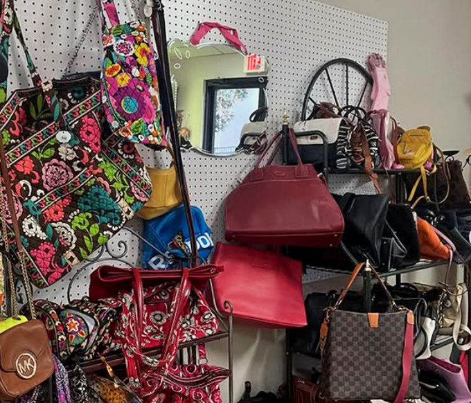 Handbag heaven where designer dreams meet bargain prices. That red leather number is practically screaming for a night out.