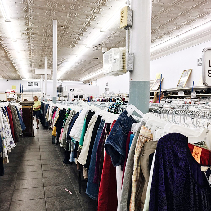 Fashion history lessons hanging on metal racks under vintage tin ceilings. Each garment represents both someone's past and someone else's future find.