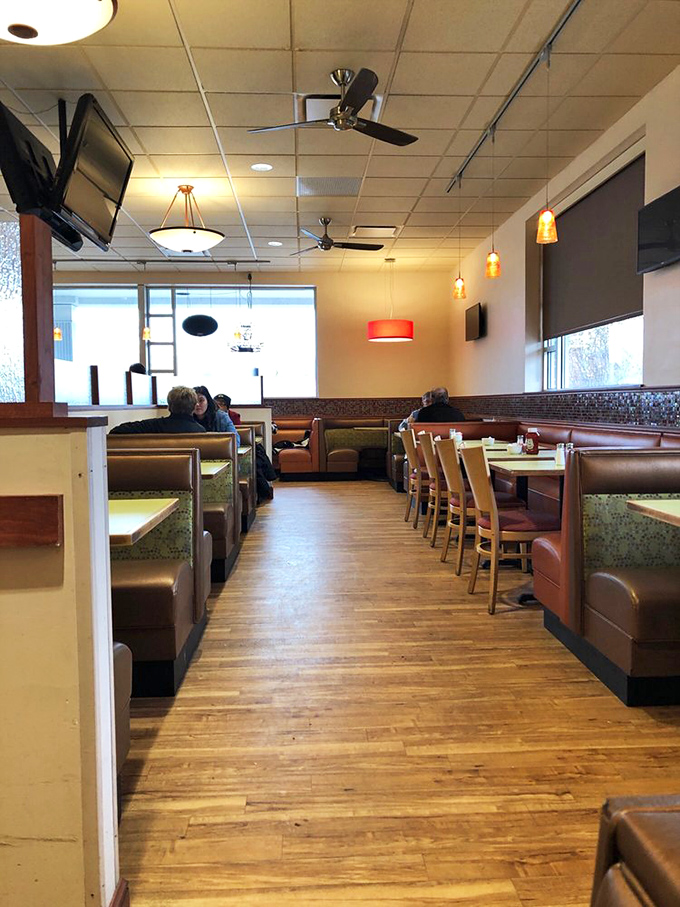 The well-worn wooden floor has supported decades of hungry patrons, creating a path that practically guides you to your booth.