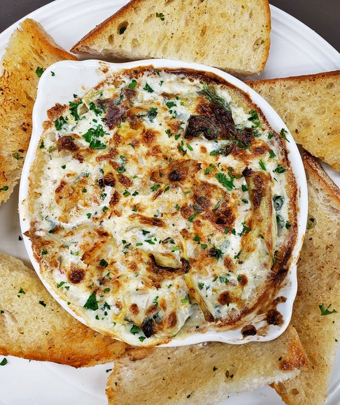This bubbling artichoke dip isn't just an appetizer&mdash;it's a social event. The toast points are merely vehicles for maximum cheese delivery.