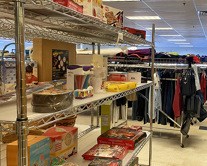 Metal shelving showcases kitchen gadgets and household helpers. That vertical roasting wok might be the missing piece to someone's culinary ambitions.