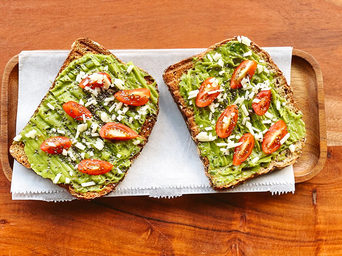 Avocado toast that puts your homemade version to shame. Those tomatoes are playing their supporting role with Oscar-worthy commitment.