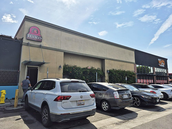 Even from the parking lot, you can sense something special awaits. That pink brick oven logo promises authentic Neapolitan magic inside.