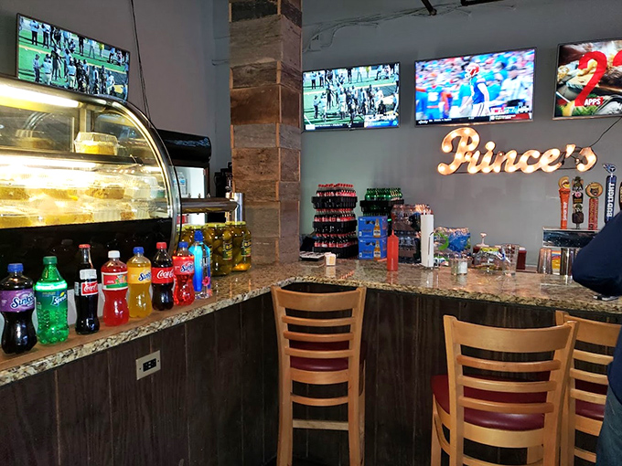 The bar area: where cold beverages stand ready to extinguish the flames. Those TVs aren't for entertainment&mdash;they're to distract you from the heat.