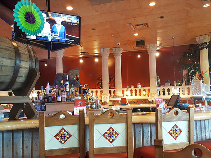 The bar area combines rustic charm with festive flair – those decorative columns and colorful tile work creating an atmosphere worth toasting to.