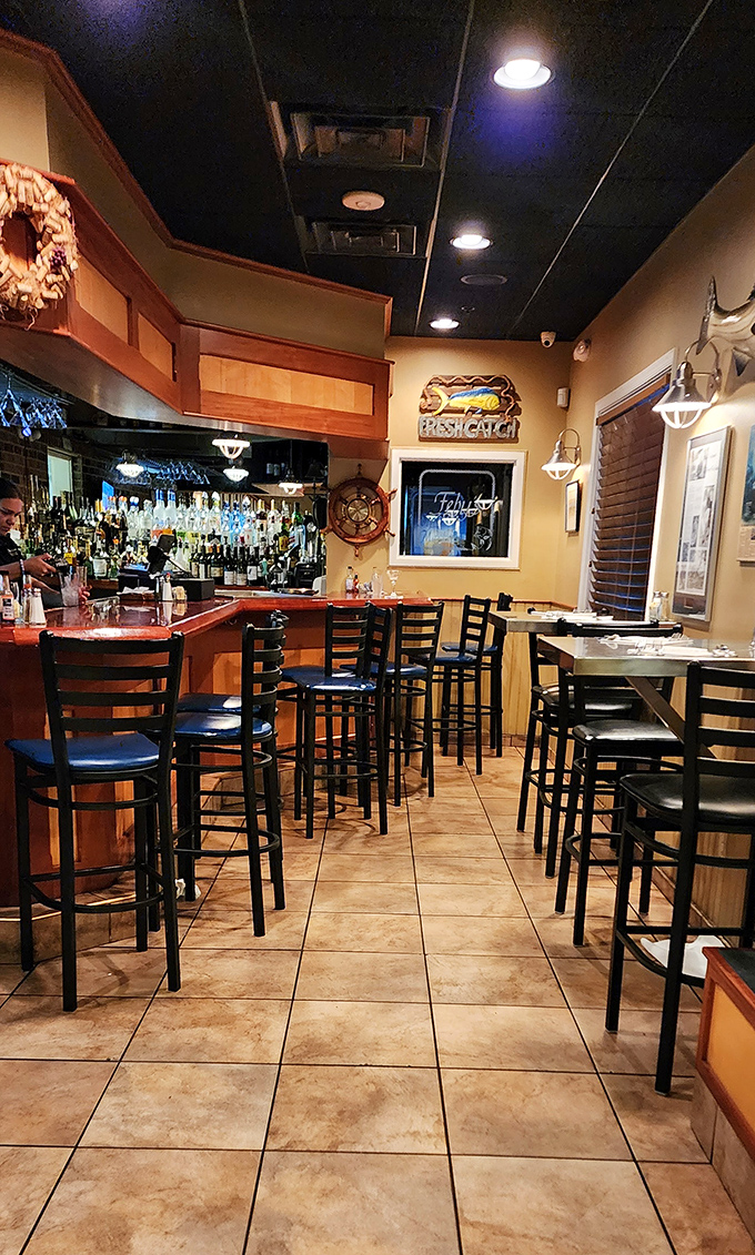 The cozy bar area invites lingering over drinks while maritime decor sets the perfect coastal mood.