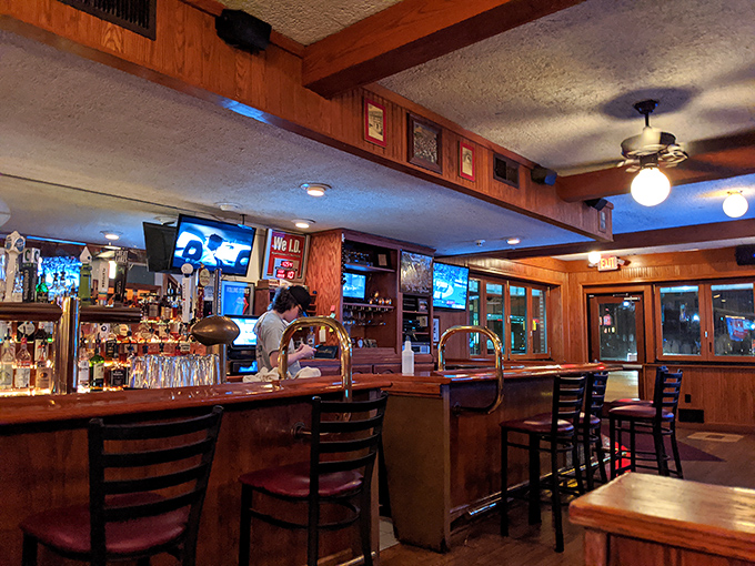 The bar where everybody might not know your name yet, but they will by halftime. Wood, warmth, and the promise of cold drinks.