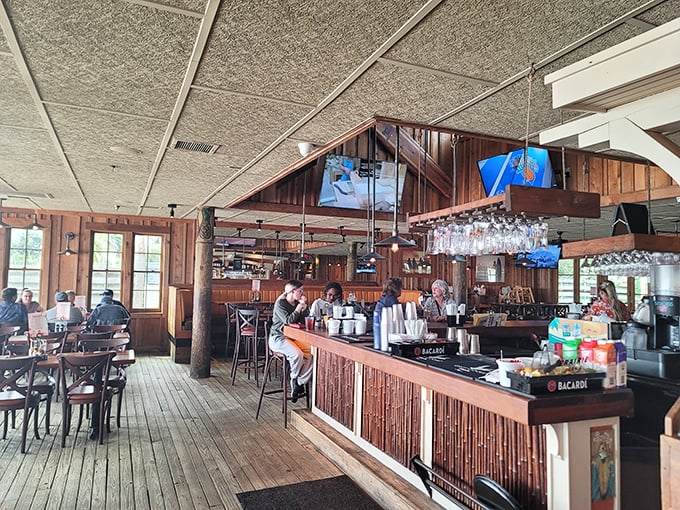 The bar where lifetime friendships are formed over shared hot sauce bottles and fish stories that grow taller with each drink.