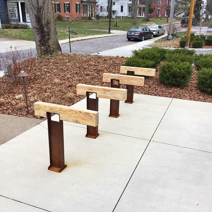 Even the bike rack shows thoughtful design! These wooden and metal stands aren't just functional&mdash;they're sculptures that say "we care about how you arrived."