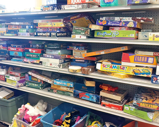 Board game paradise or family game night headquarters? These slightly worn boxes contain hours of entertainment and inevitable Monopoly arguments.