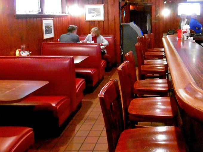 The dining room's red booths offer sanctuary for intimate conversations and serious eating. No distractions from the important business of enjoying your meal.