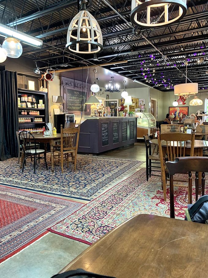 Not just a caf&eacute;, but a time-traveling dining experience. Those overlapping Persian rugs create islands of color beneath mismatched vintage chairs.